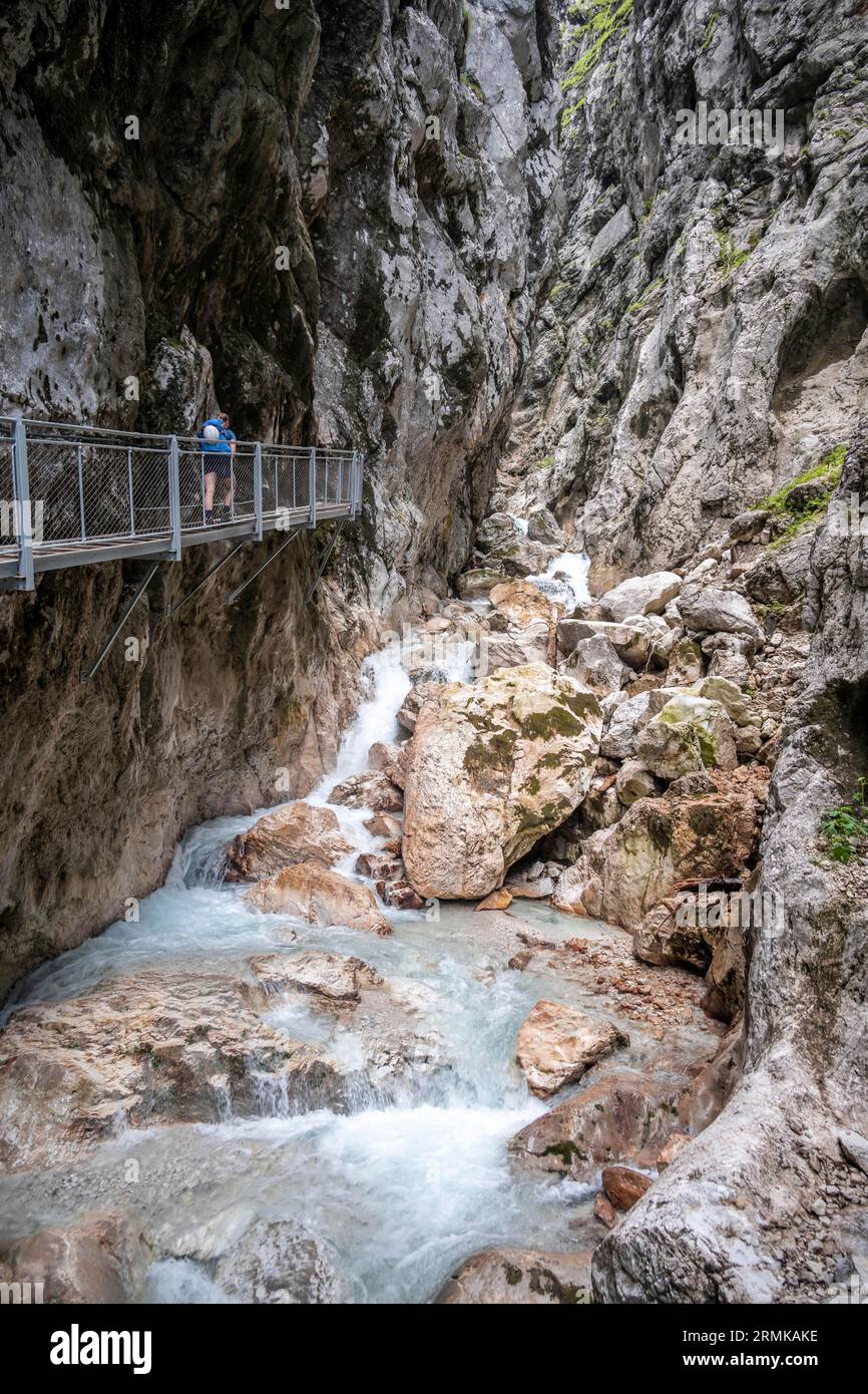 Hiker in a gorge, Hammersbach flows through Hoellentalklamm, near ...