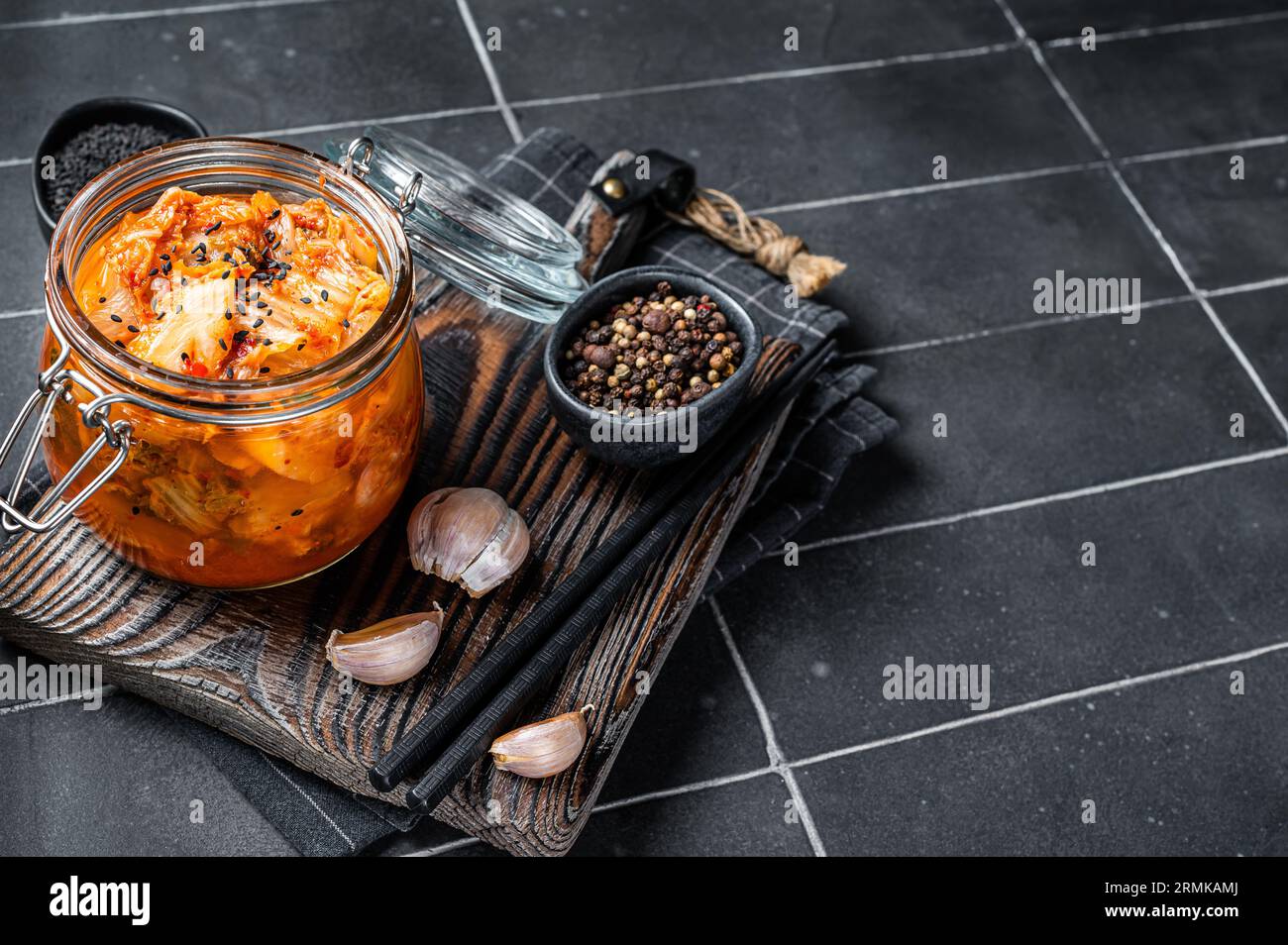 Homemade kimchi in a glass jar, traditional Korean cuisine. Black ...