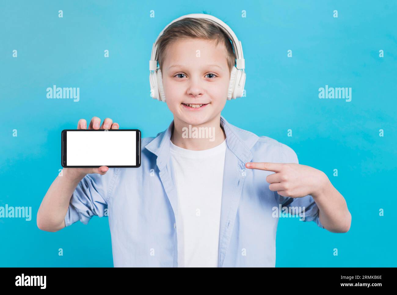 Close up boy wearing headphone head pointing her finger toward mobile ...