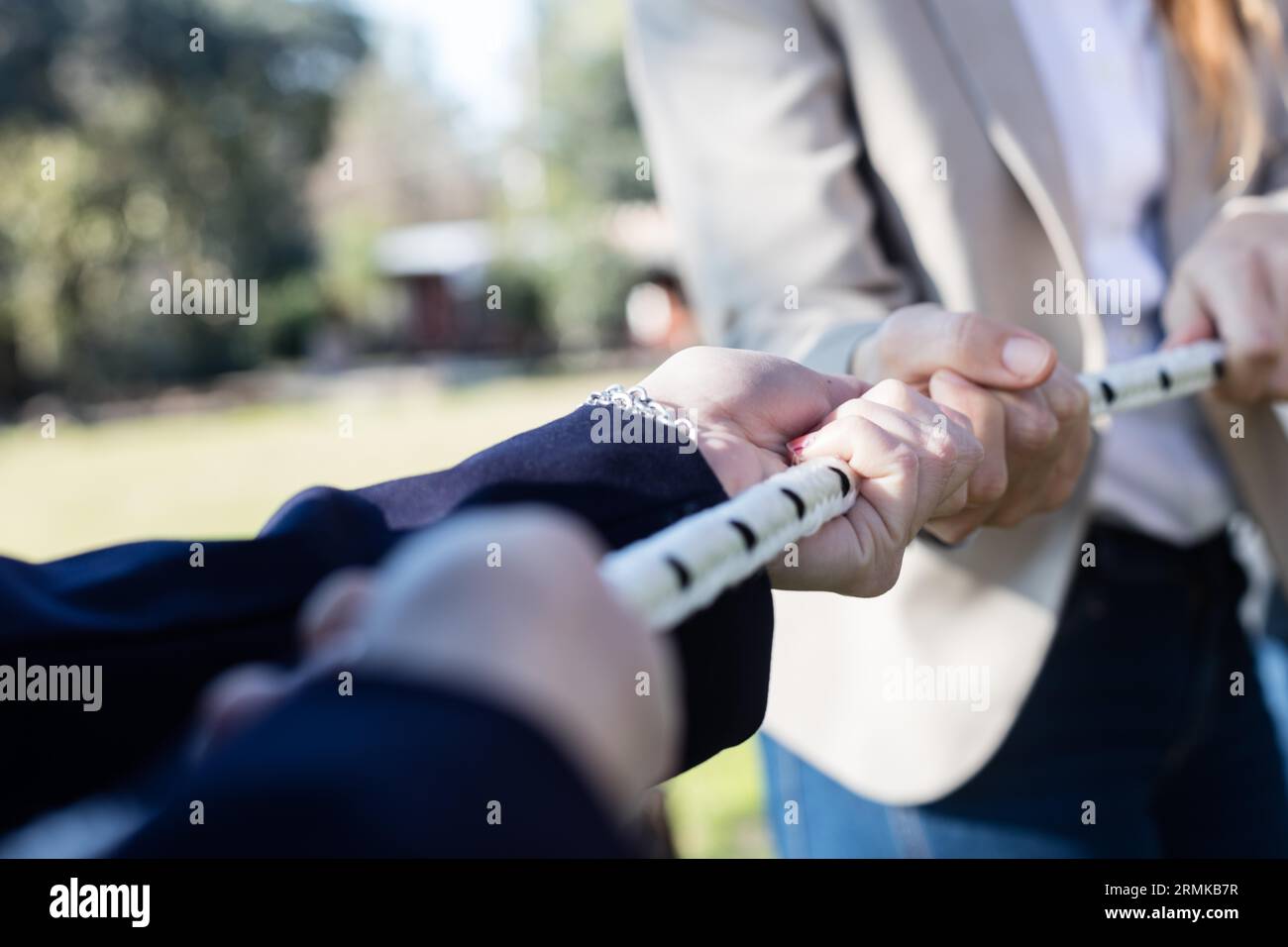 Close up hands pulling rope Stock Photo - Alamy