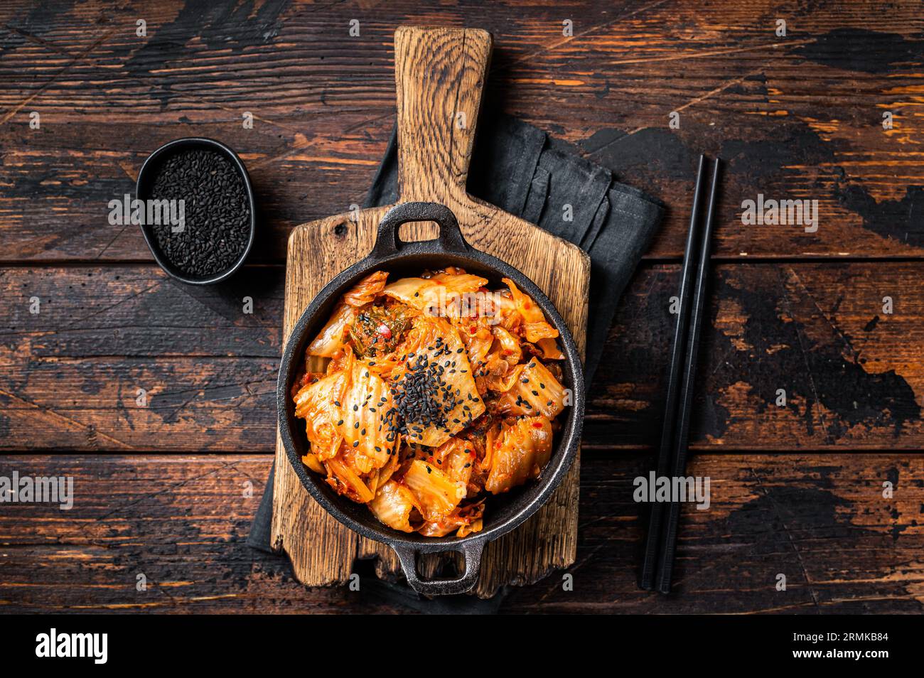 Kimchi salted and fermented chinese cabbage in a skillet. Wooden ...