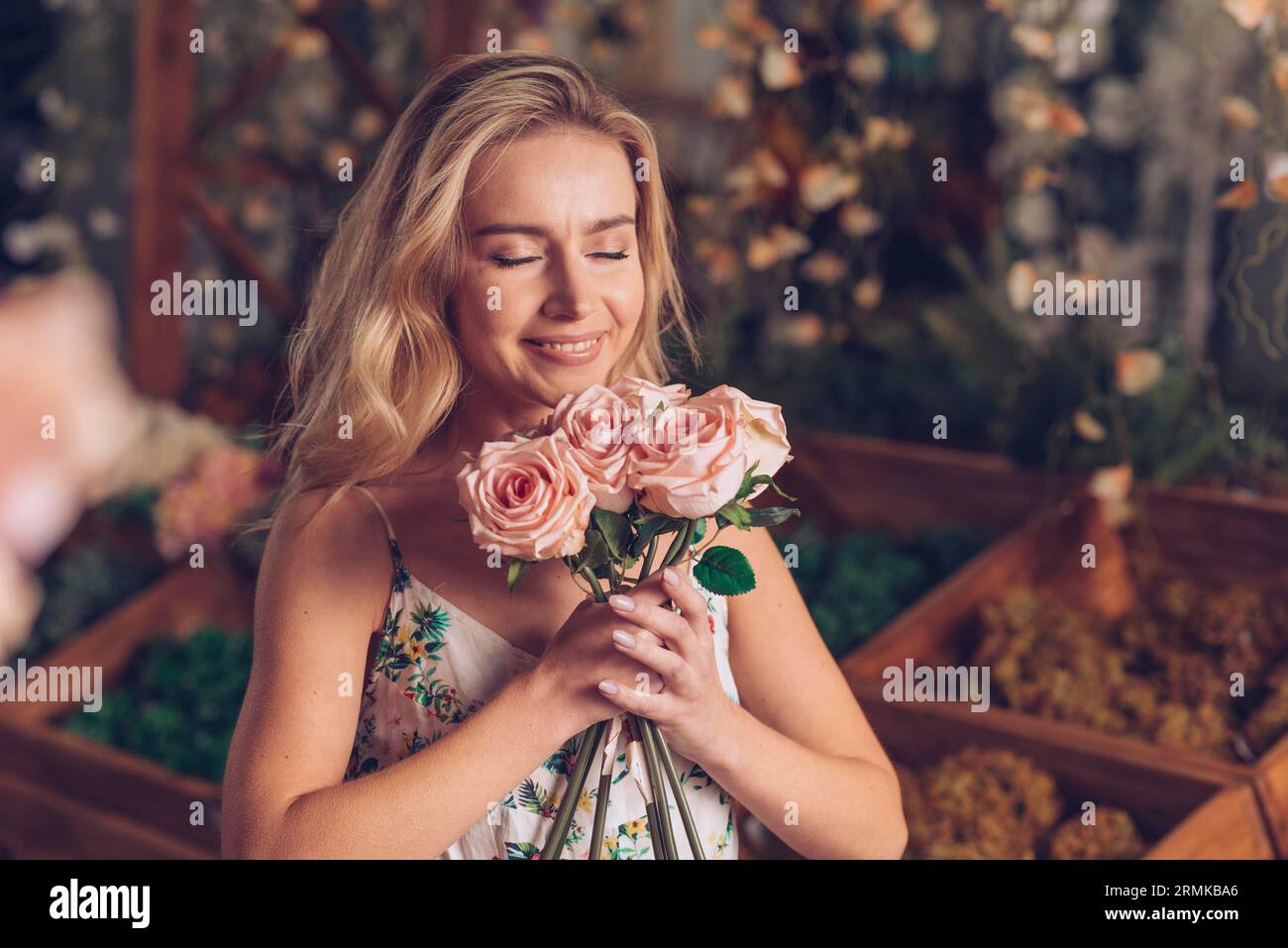 Young woman smelling roses hi-res stock photography and images - Alamy
