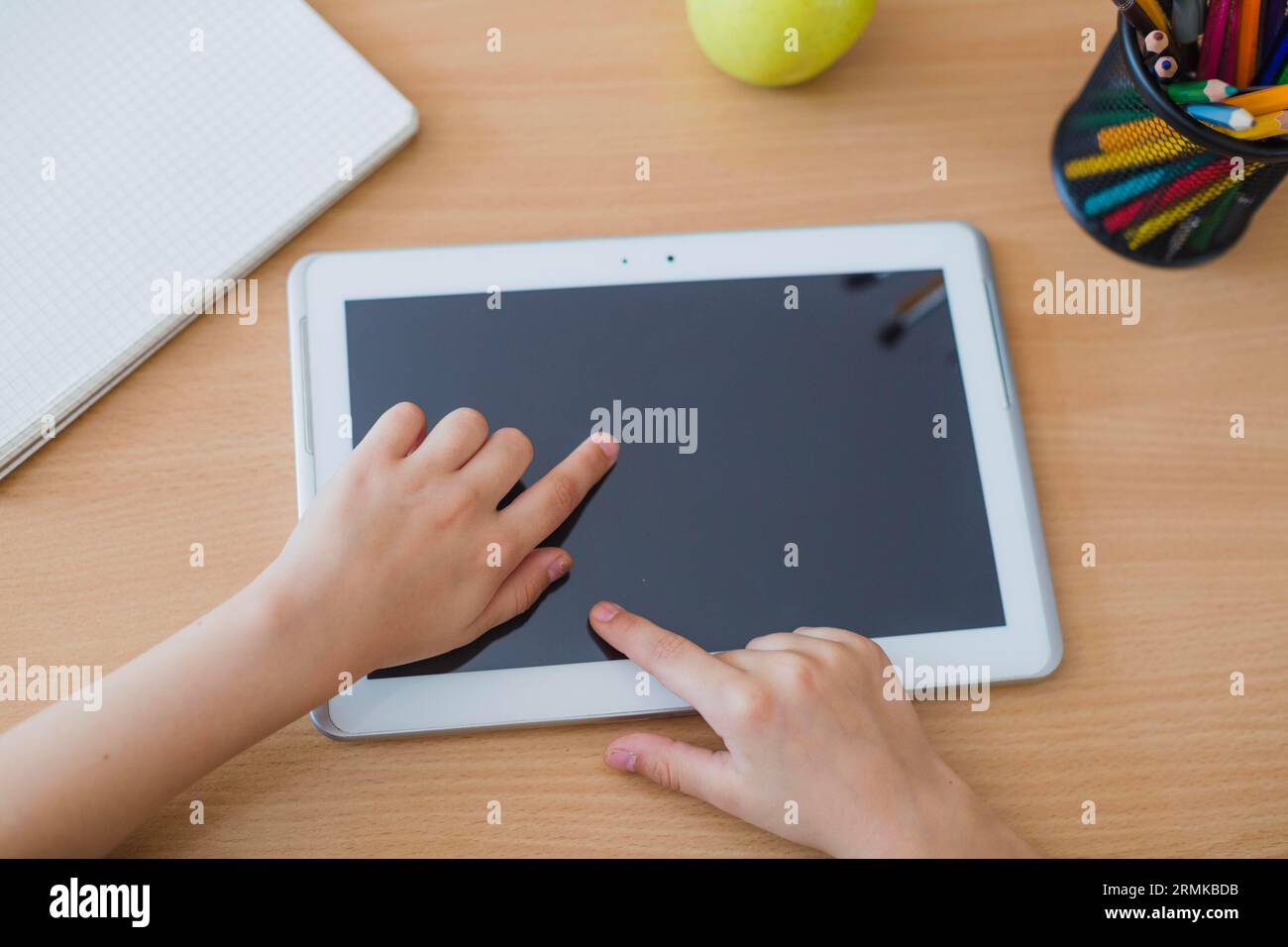 Crop child touching tablet Stock Photo - Alamy