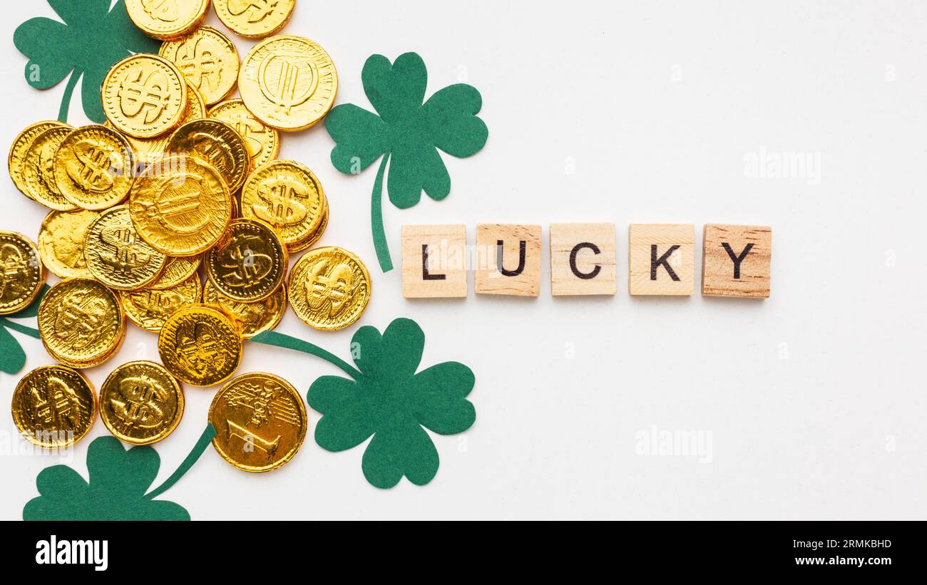 Flat lay clovers gold coins Stock Photo - Alamy