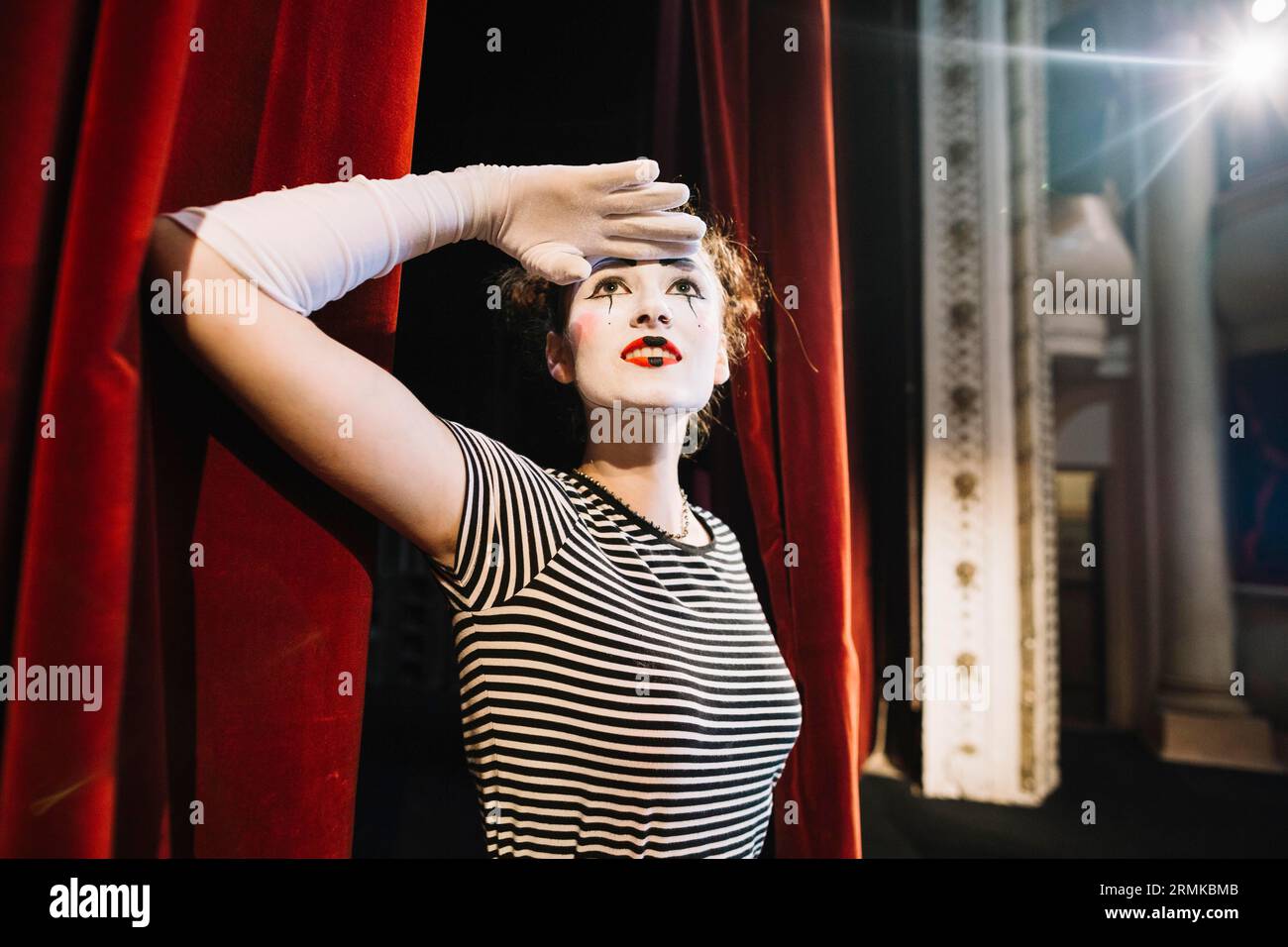 Female mime artist shielding her eyes Stock Photo - Alamy