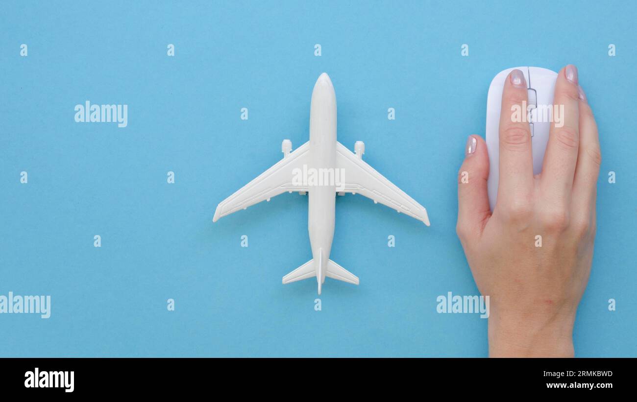 Hand with mouse beside airplane toy Stock Photo - Alamy