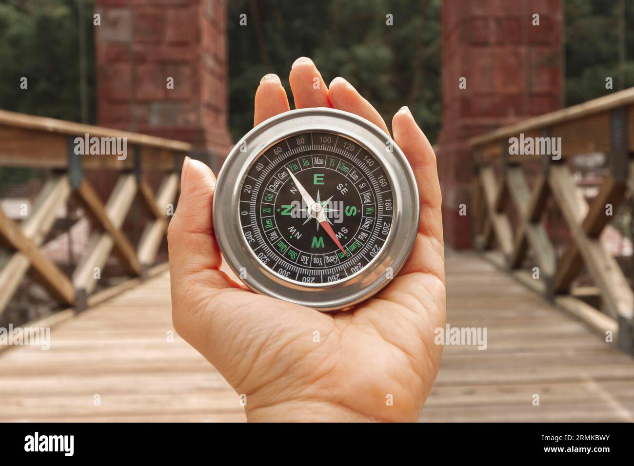 Front view woman holding compass Stock Photo - Alamy