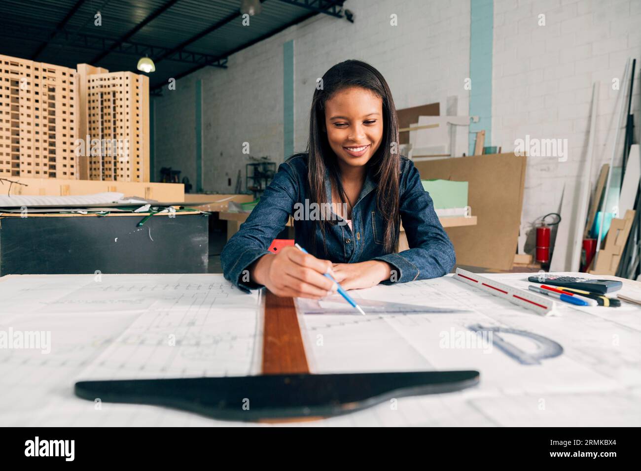 Happy african american lady with big ruler pen table Stock Photo - Alamy