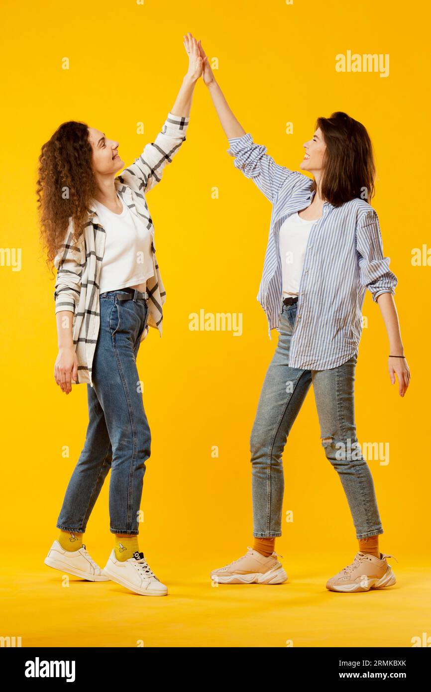 Front view friends giving high five Stock Photo - Alamy