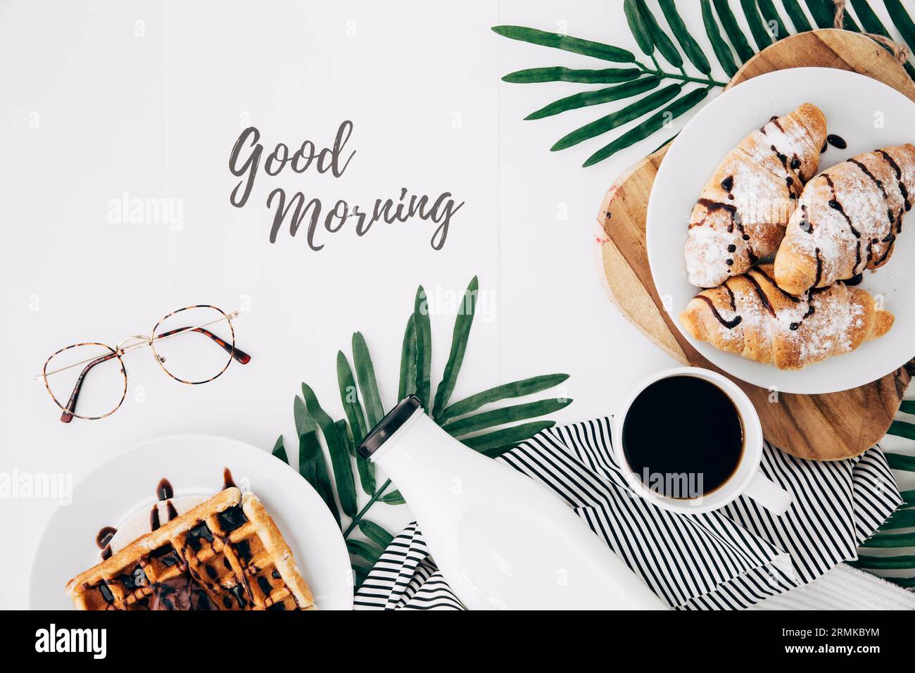 Good morning text with eyeglasses fresh baked croissant waffles bottle ...