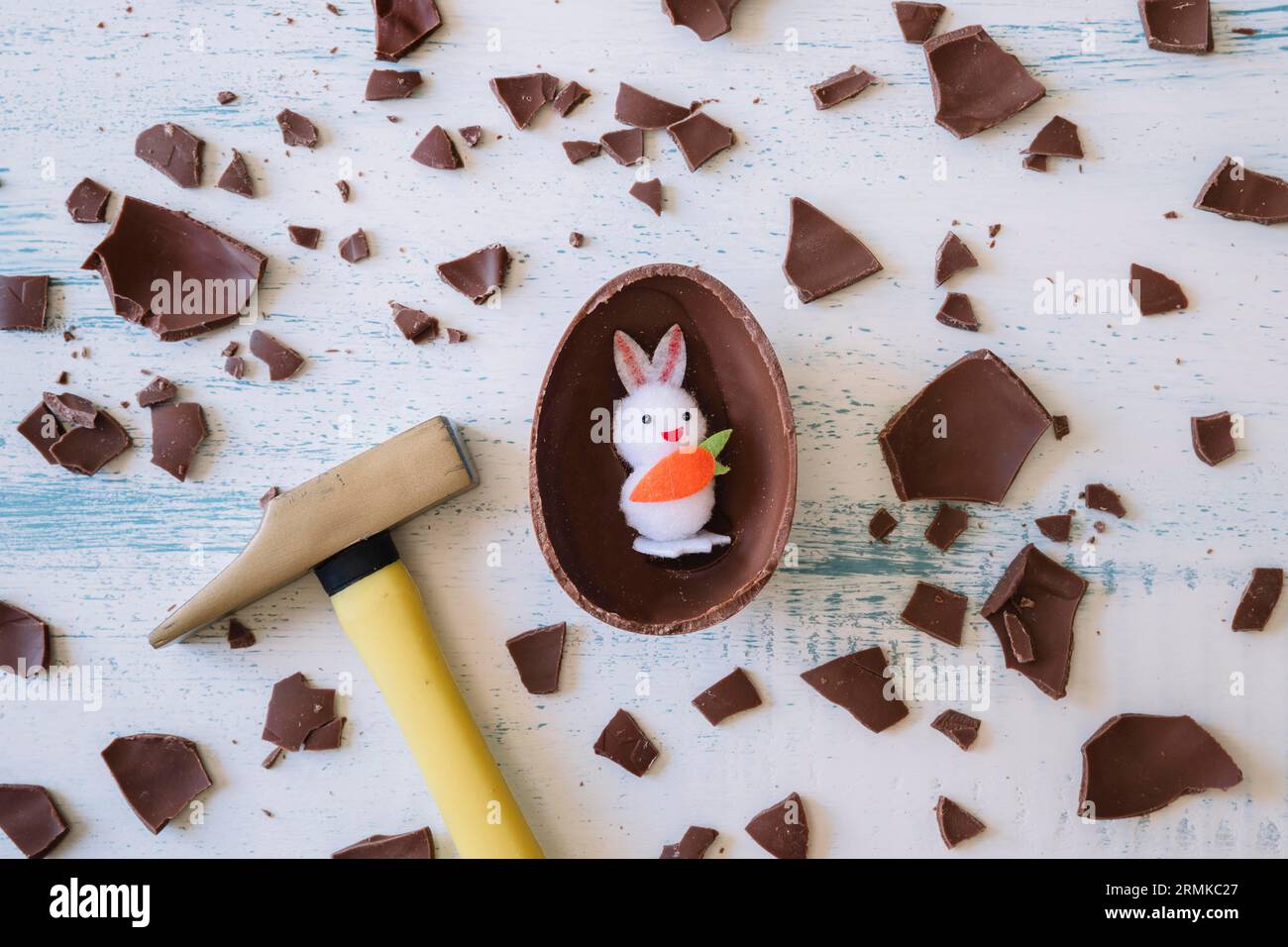 Hammer near chocolate egg bunny Stock Photo - Alamy