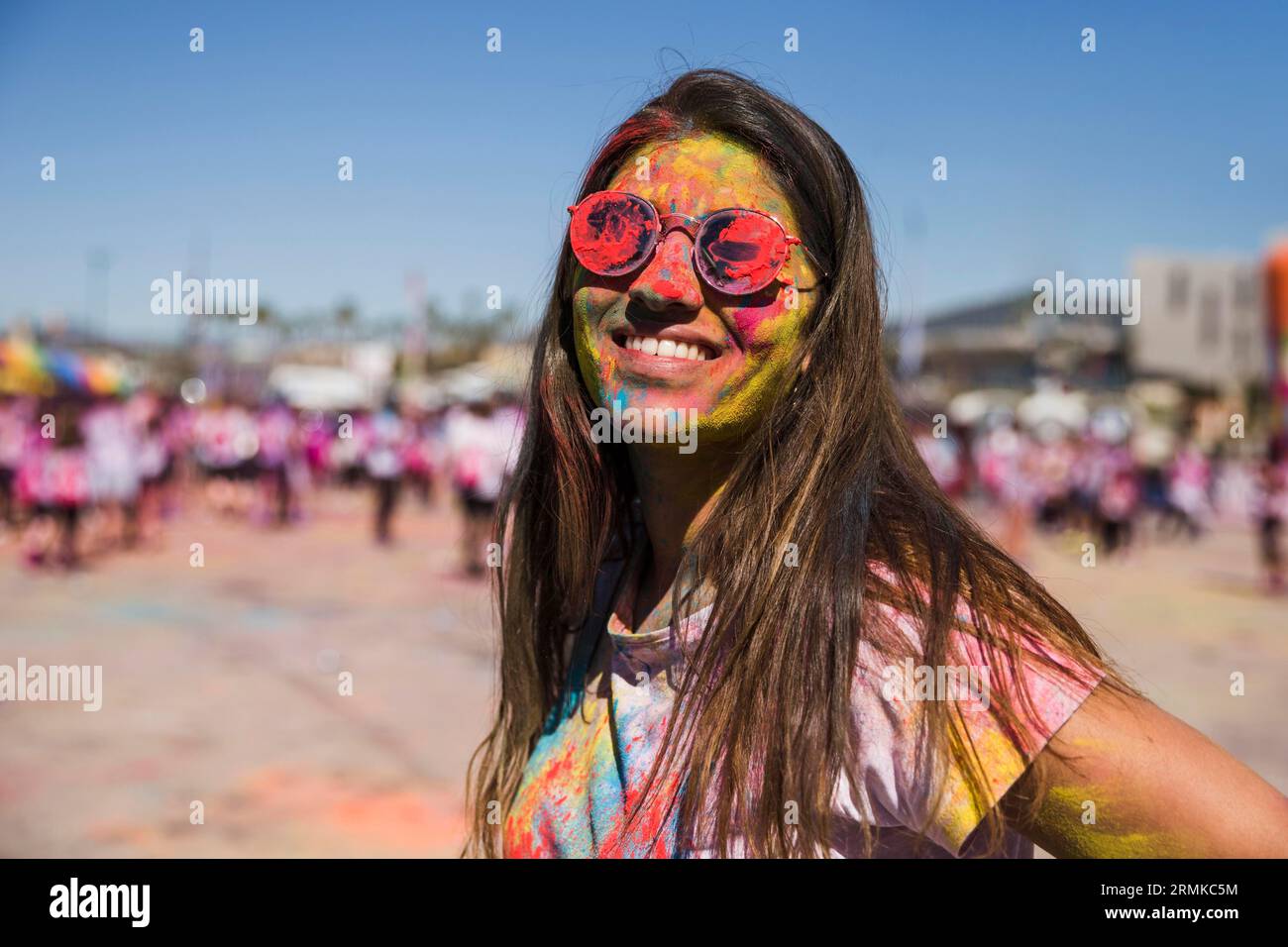 Holi color woman s face looking camera Stock Photo - Alamy