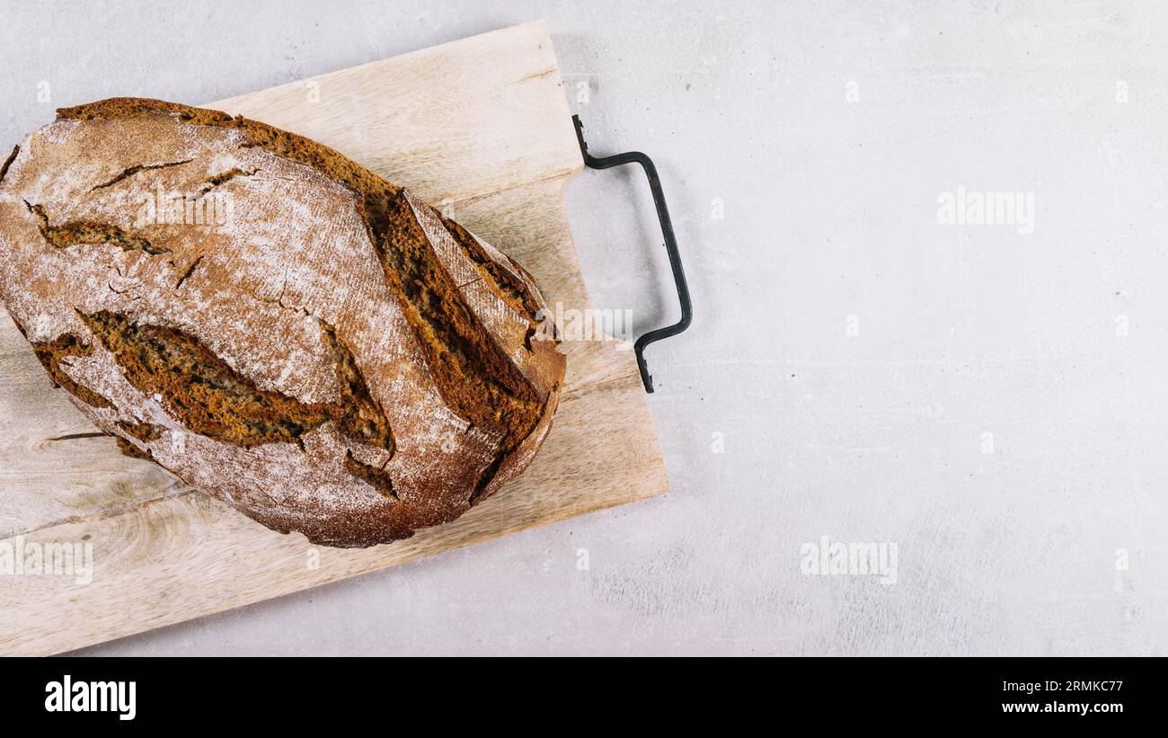 Loaf rustic baked bread chopping board white background Stock Photo - Alamy