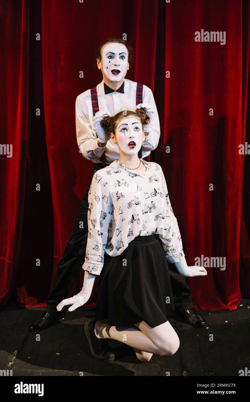 Male mime artist placing his hand female mime s hair buns Stock Photo ...