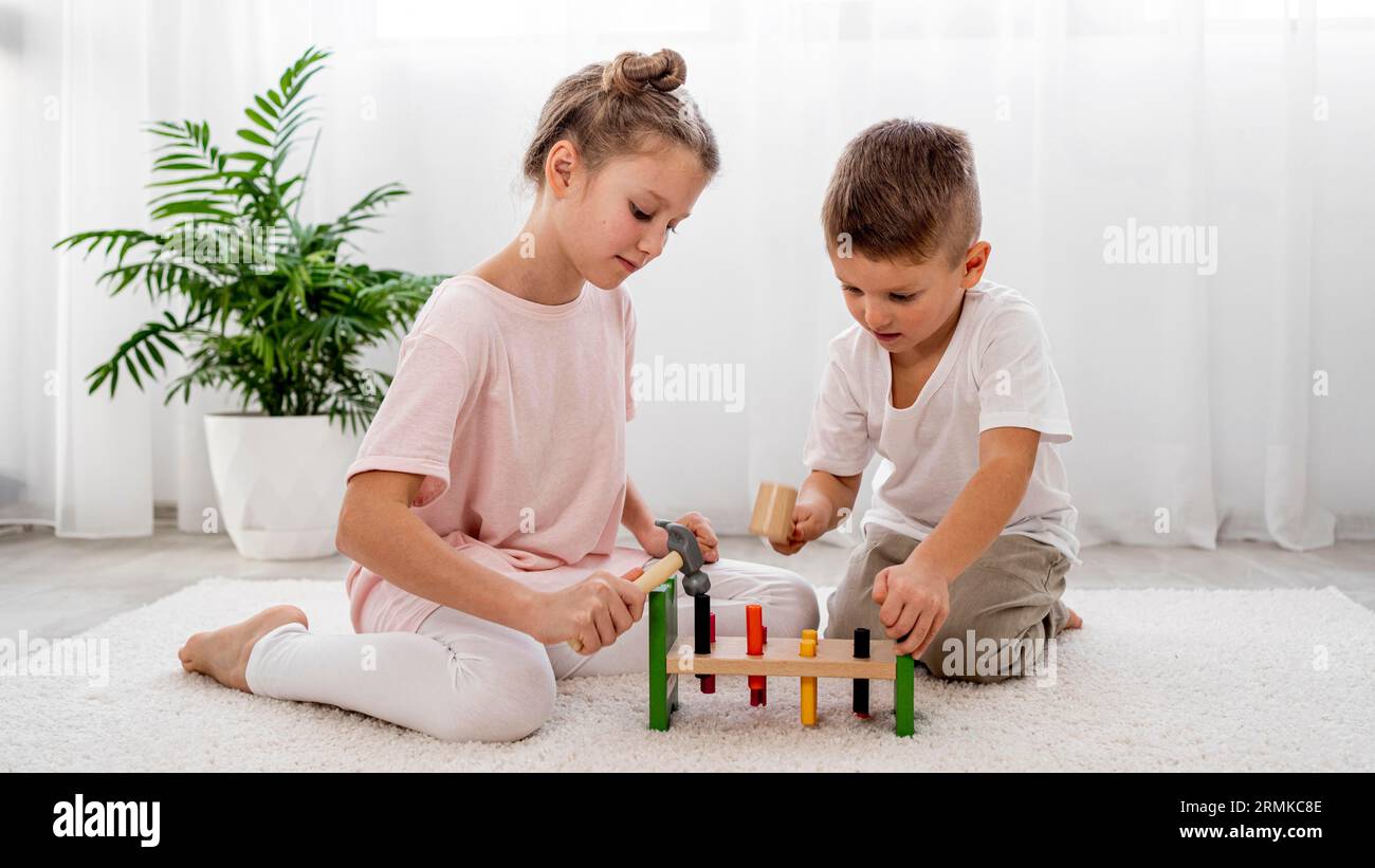 Kids playing with colorful game together Stock Photo - Alamy