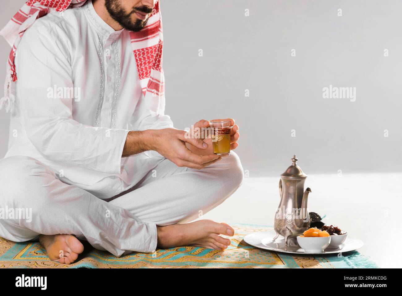 Muslim man holding tiny cup traditional tea Stock Photo - Alamy