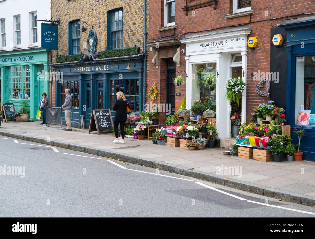 Colourful Georgian shops with pavement displays on Highgate High Street ...