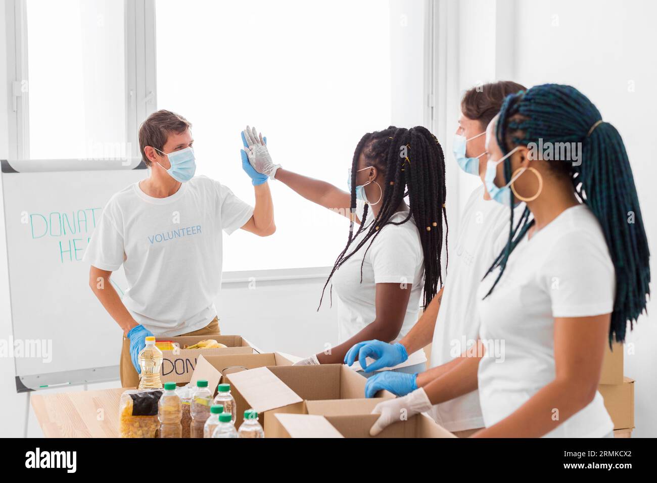 Side view people making donations packages Stock Photo - Alamy