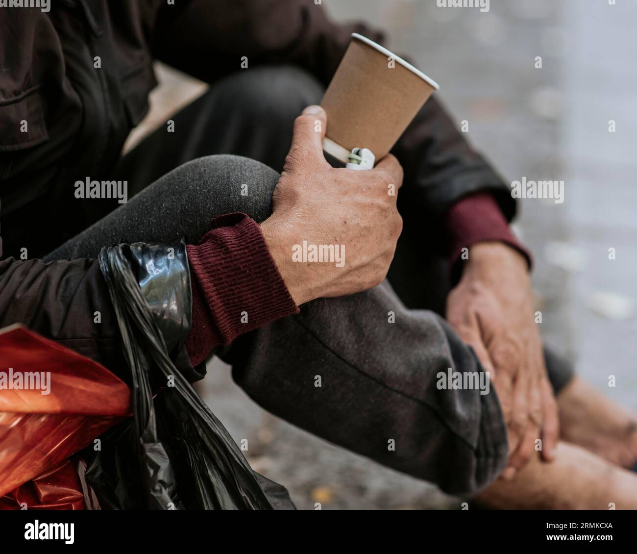 Side view homeless man holding cup Stock Photo - Alamy