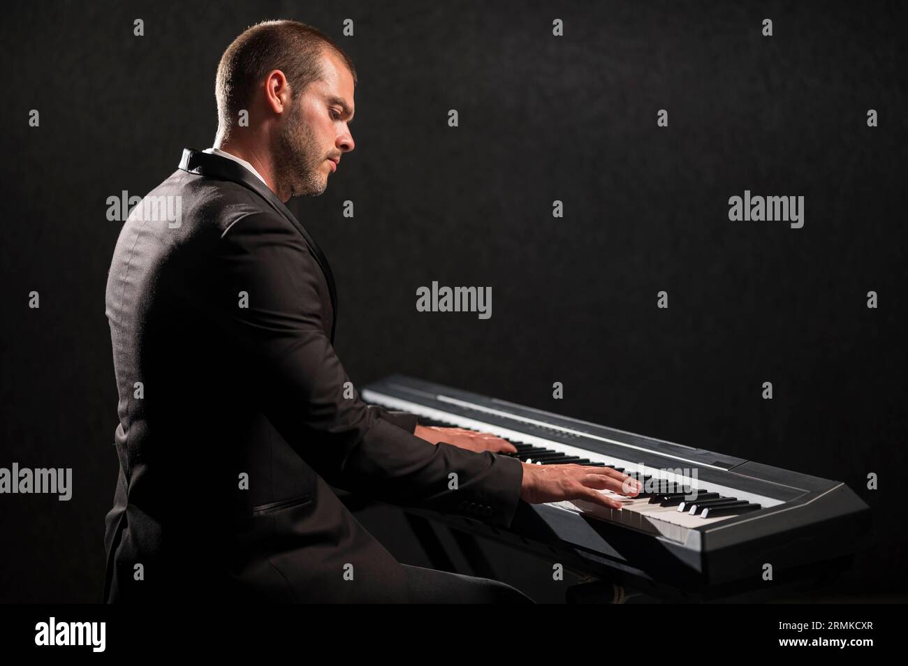 Side view person playing digital midi piano Stock Photo - Alamy