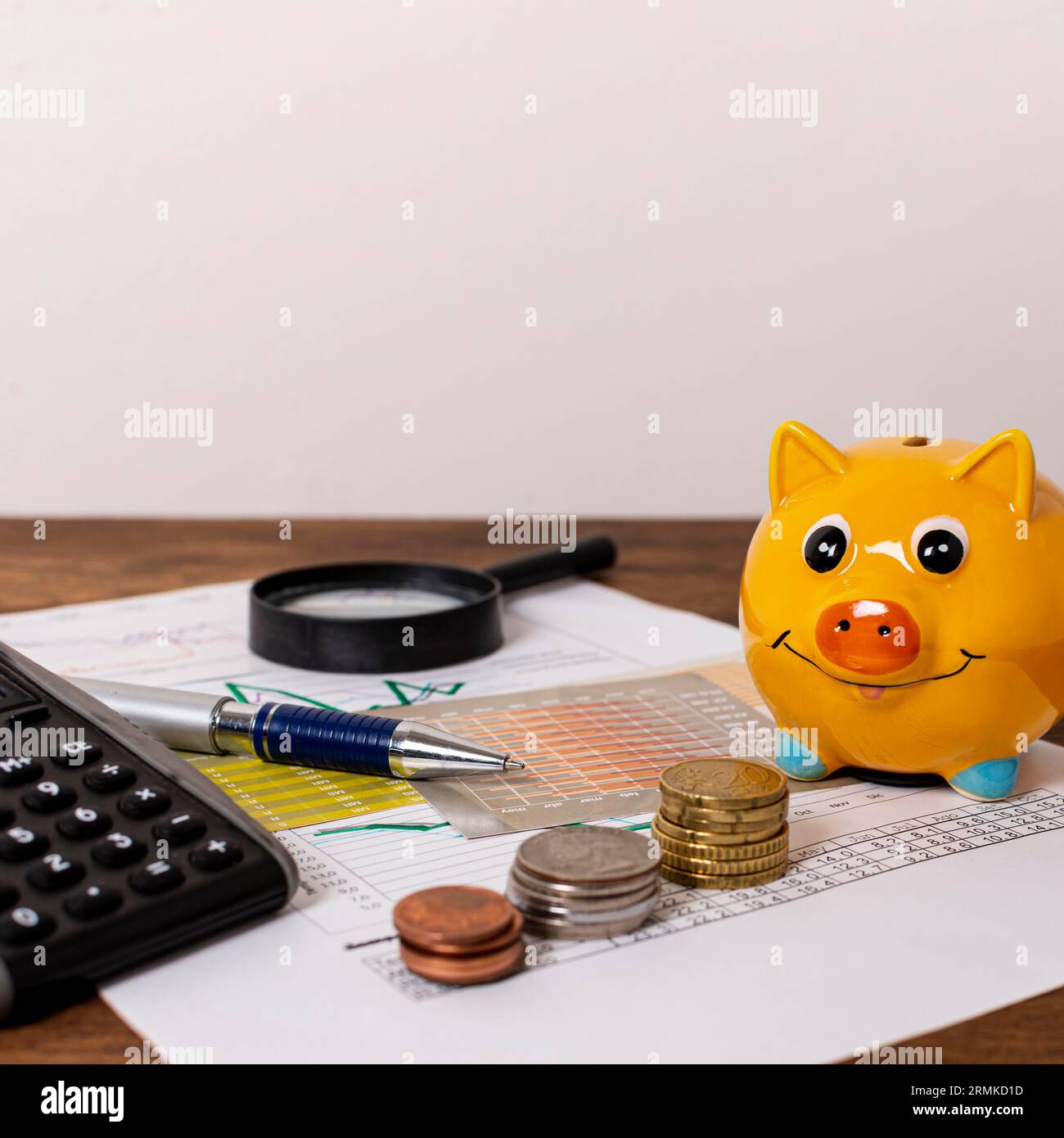 Stationery items piggy bank with money Stock Photo - Alamy