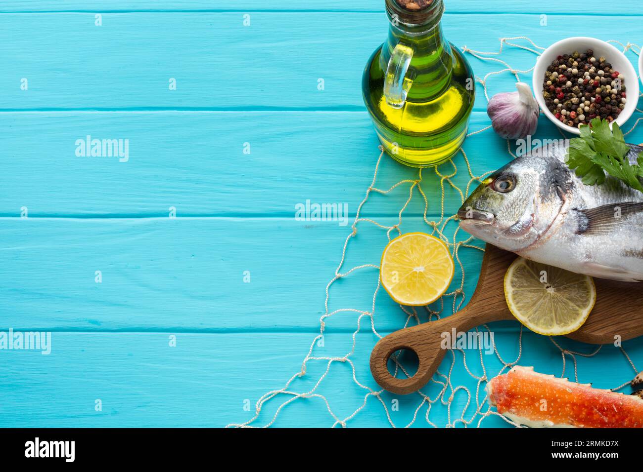 Top view fish with condiments oil Stock Photo - Alamy