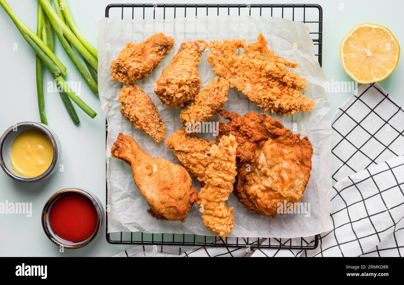 Top view fried chicken tray with sauces green onions lemon Stock Photo ...