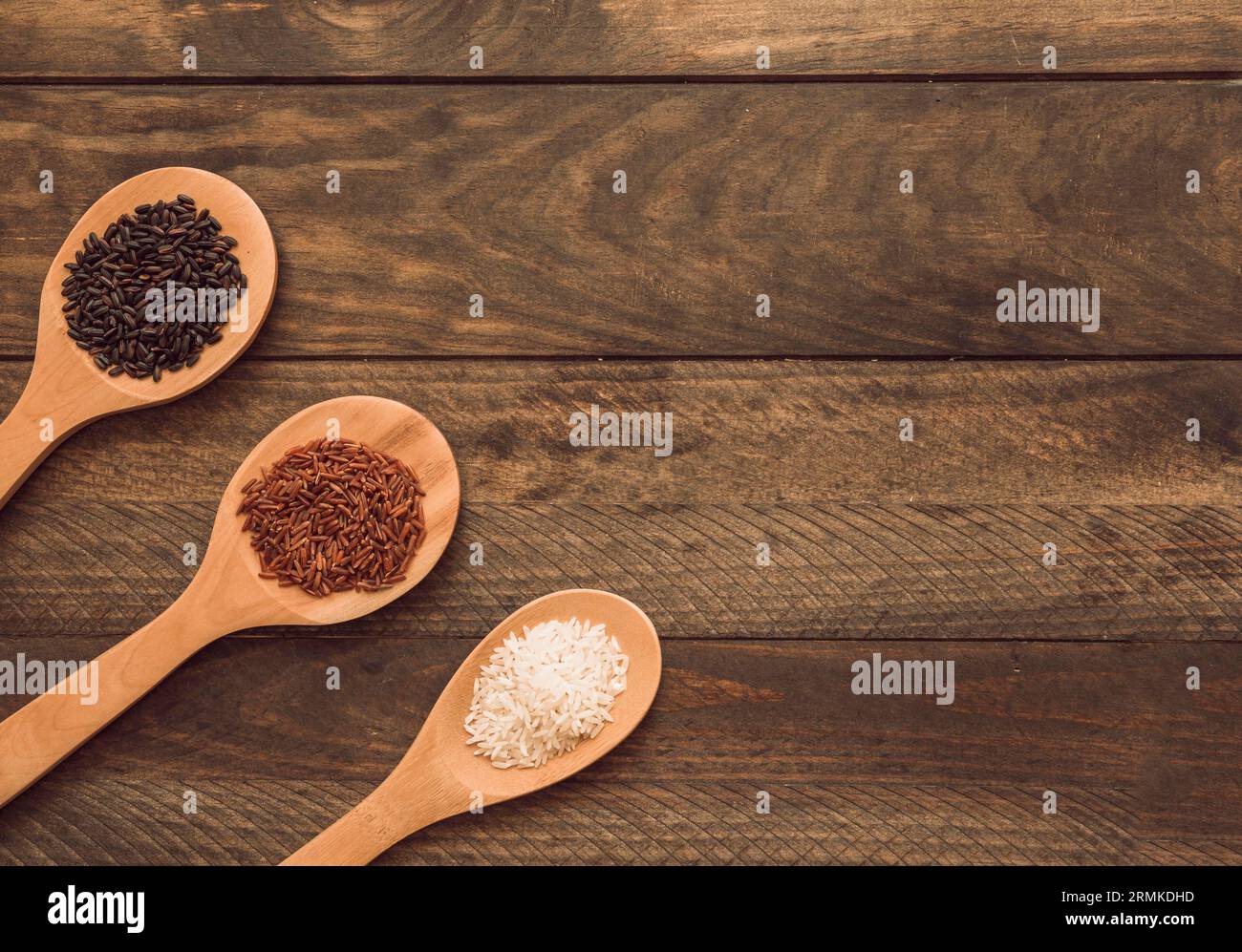Wooden spoons with three different type rice grains wooden plank Stock ...