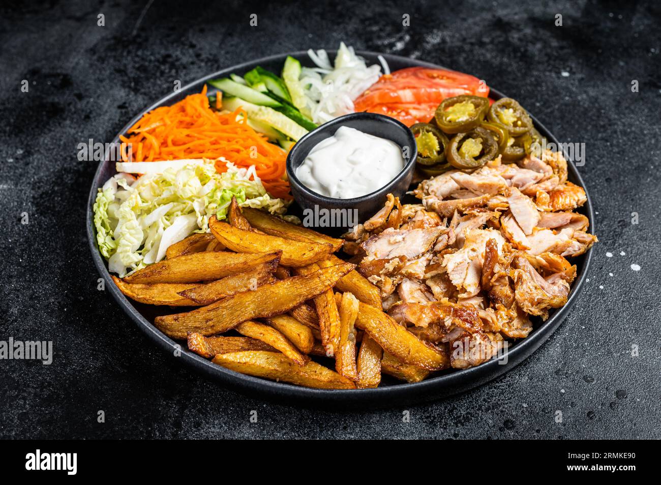 Shawarma Doner kebab on a plate with french fries and salad. Black ...