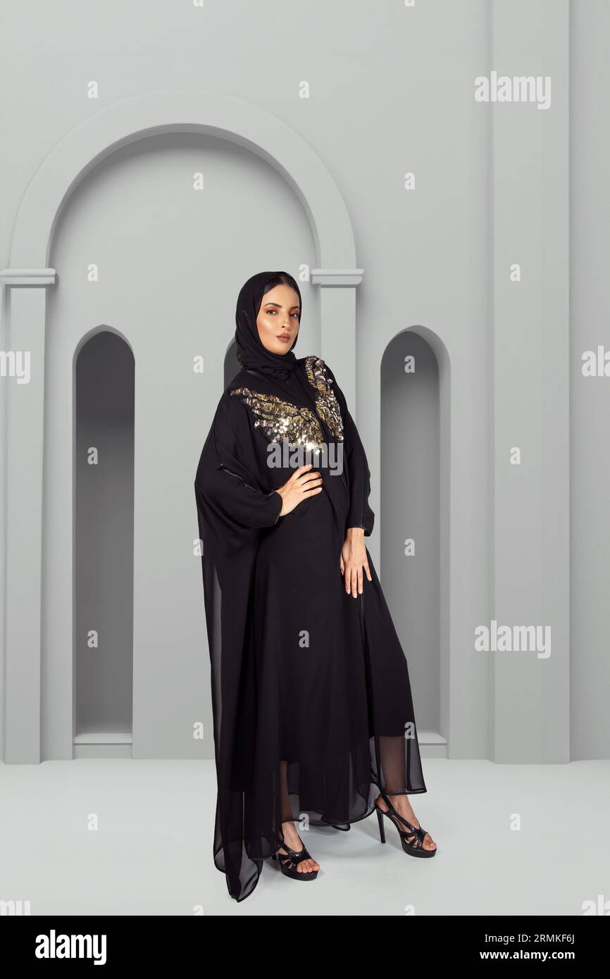 Asian Model poses for Arabic designer Abaya on isolated background ...