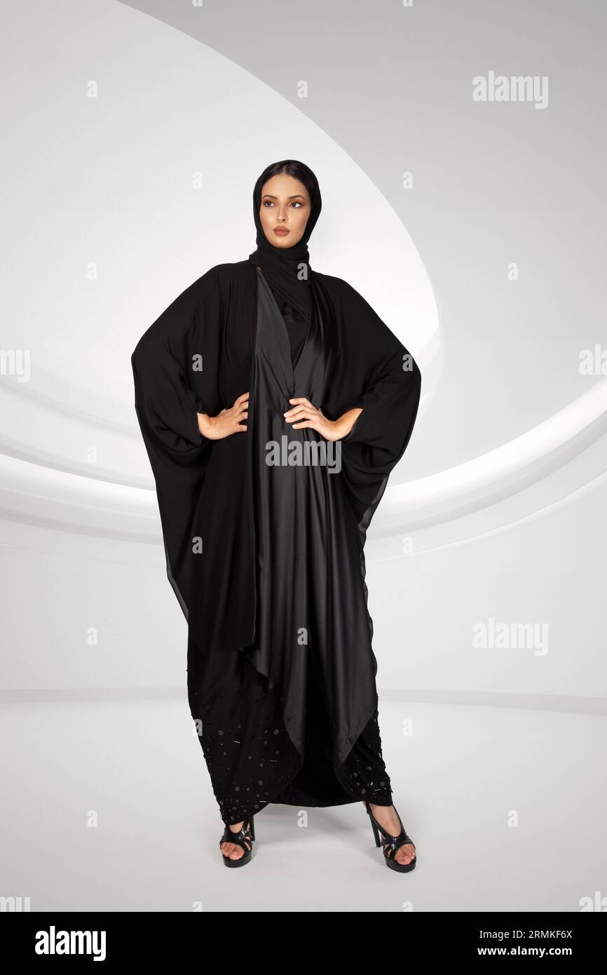 Asian Model poses for Arabic designer Abaya on isolated background ...
