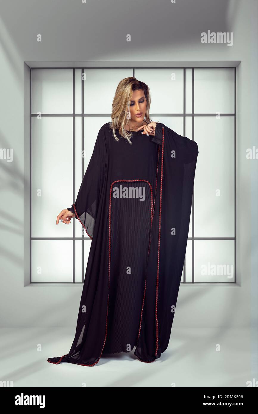 Asian Model poses for Arabic designer Abaya on isolated background ...