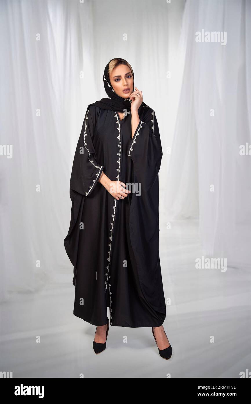 Asian Model poses for Arabic designer Abaya on isolated background ...