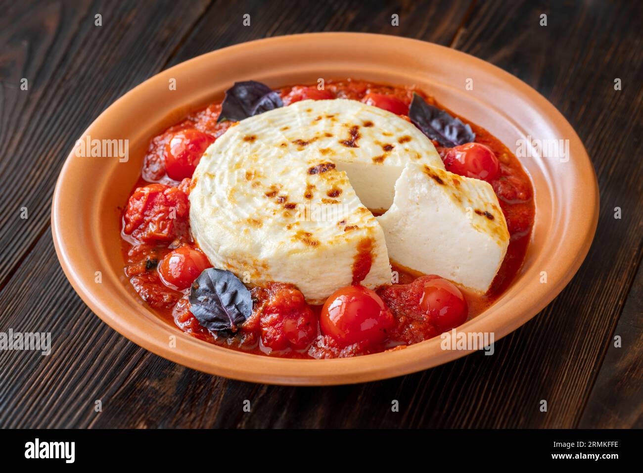 Oven Baked Ricotta cheese with tomato sauce Stock Photo - Alamy
