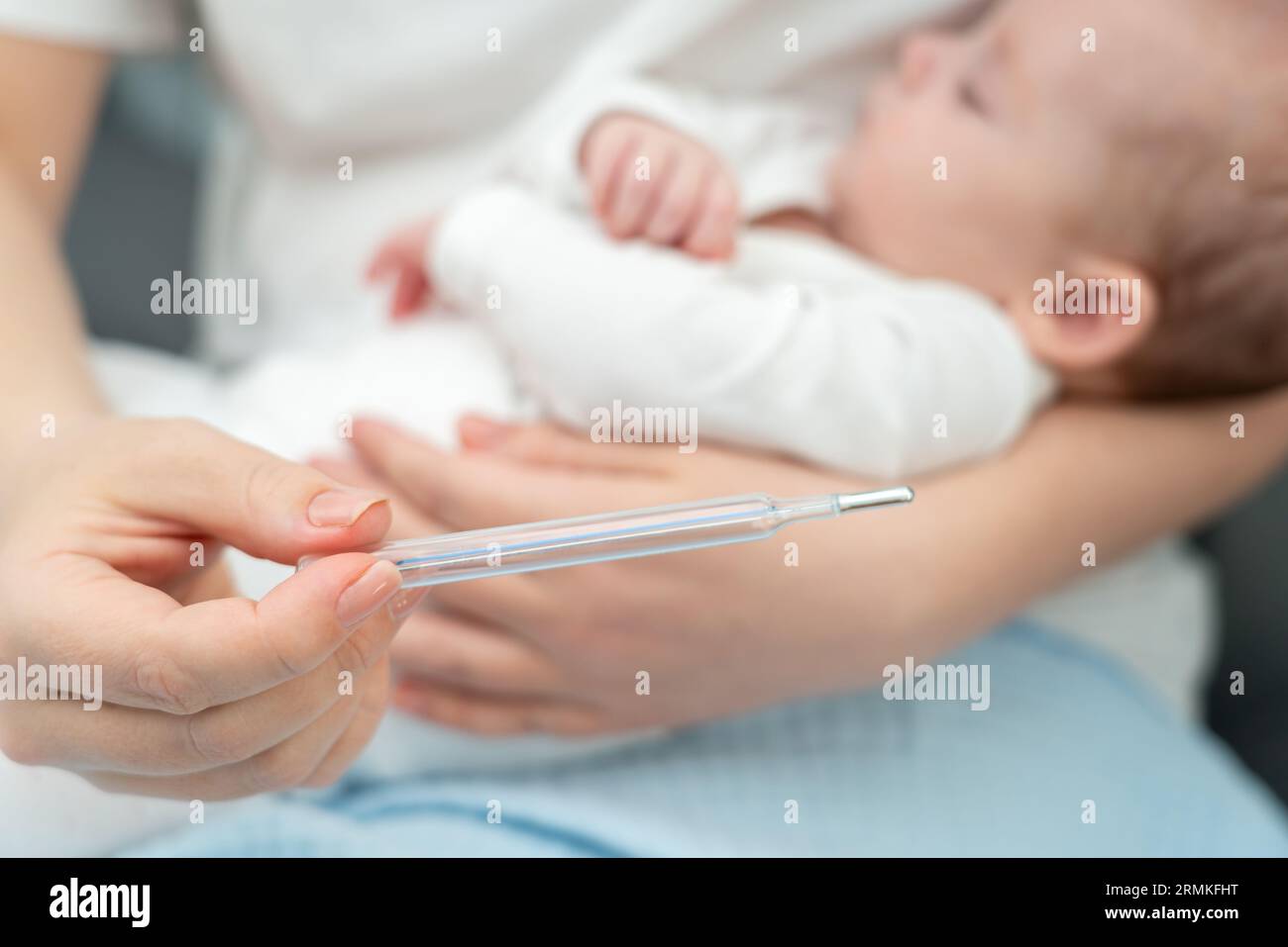 Mother checks newborn's temperature, Concept of healthcare at home ...