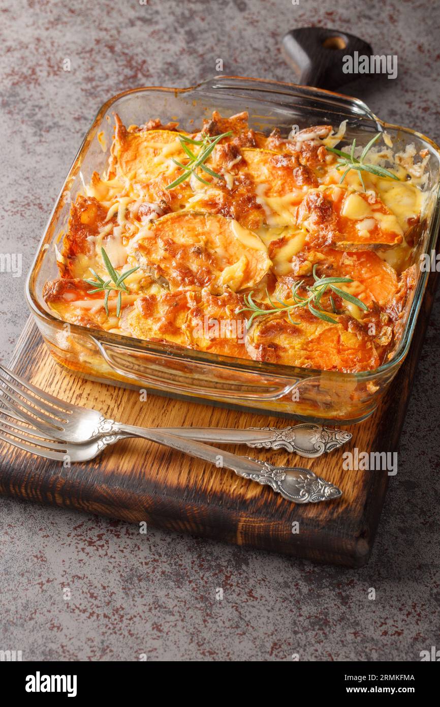Vegetarian sweet potato gratin with cheddar cheese and rosemary close ...