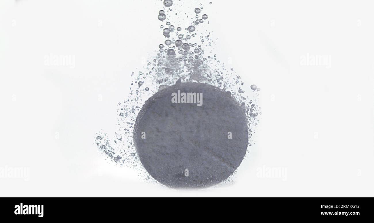 Tablets Falling and Dissolving into a Glass of Water against White ...