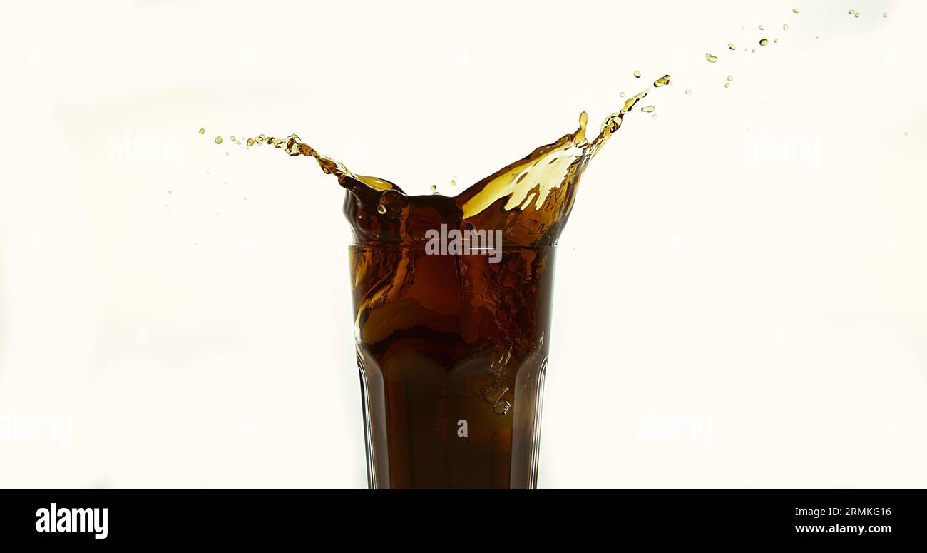 Ice Cubes Falling into Glass of Coke against White Background Stock ...