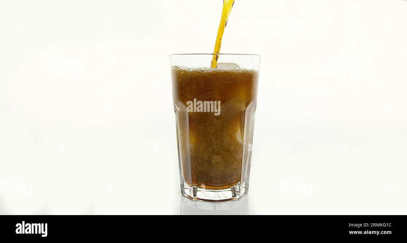 Ice Cubes Falling into Glass of Coke against White Background Stock ...