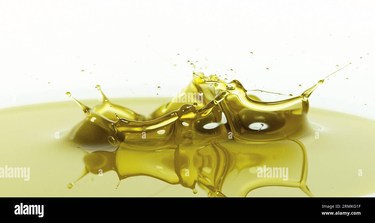 Olives Falling into Olive Oil against White Background Stock Photo - Alamy
