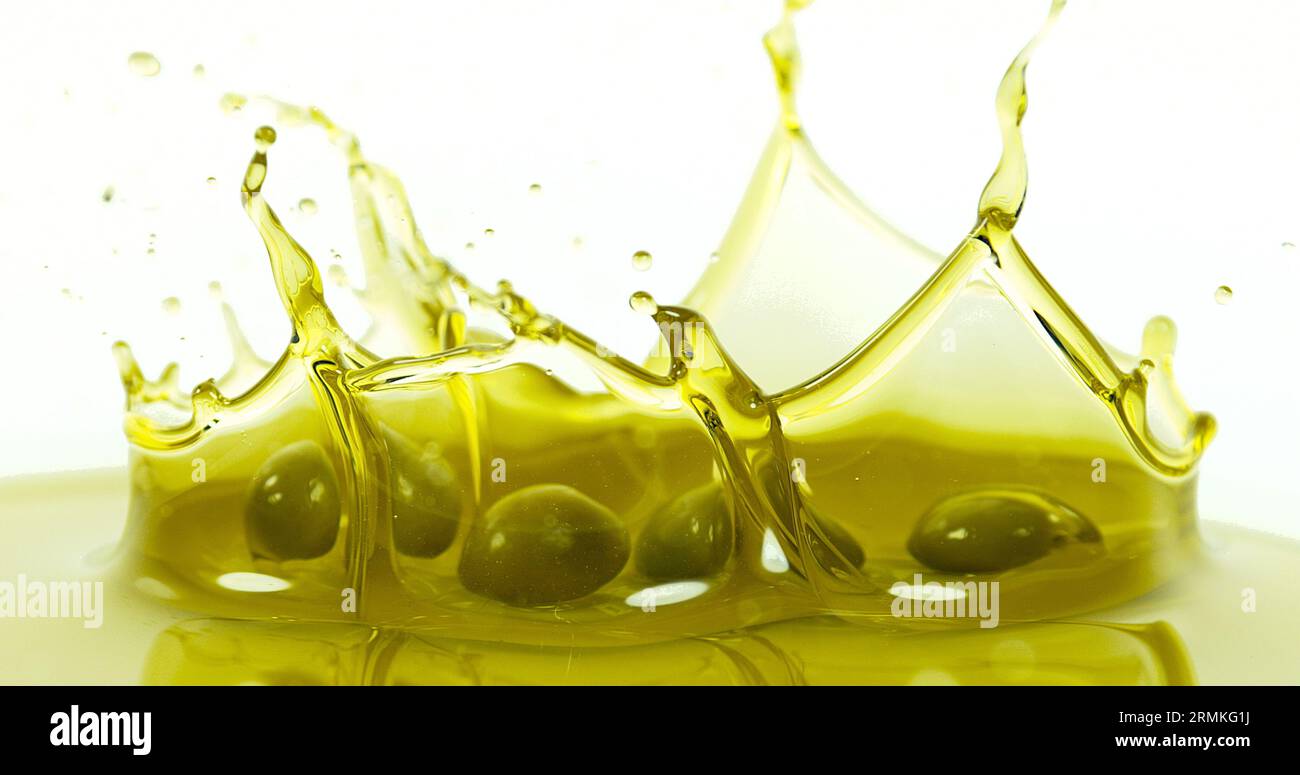 Olives Falling into Olive Oil against White Background Stock Photo - Alamy