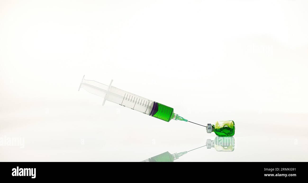 Syringe Falling against White Background Stock Photo - Alamy