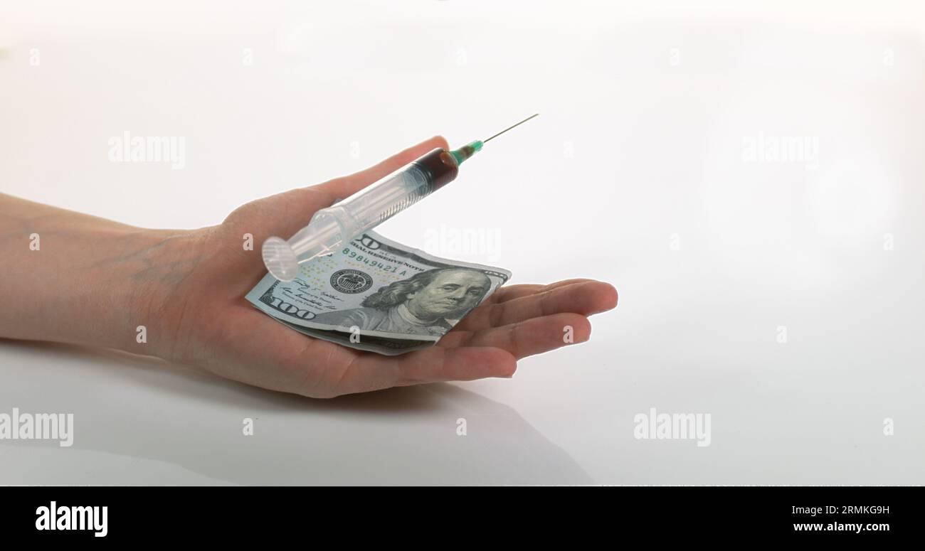 Syringe Falling into Hand with Dollars against White Background Stock ...