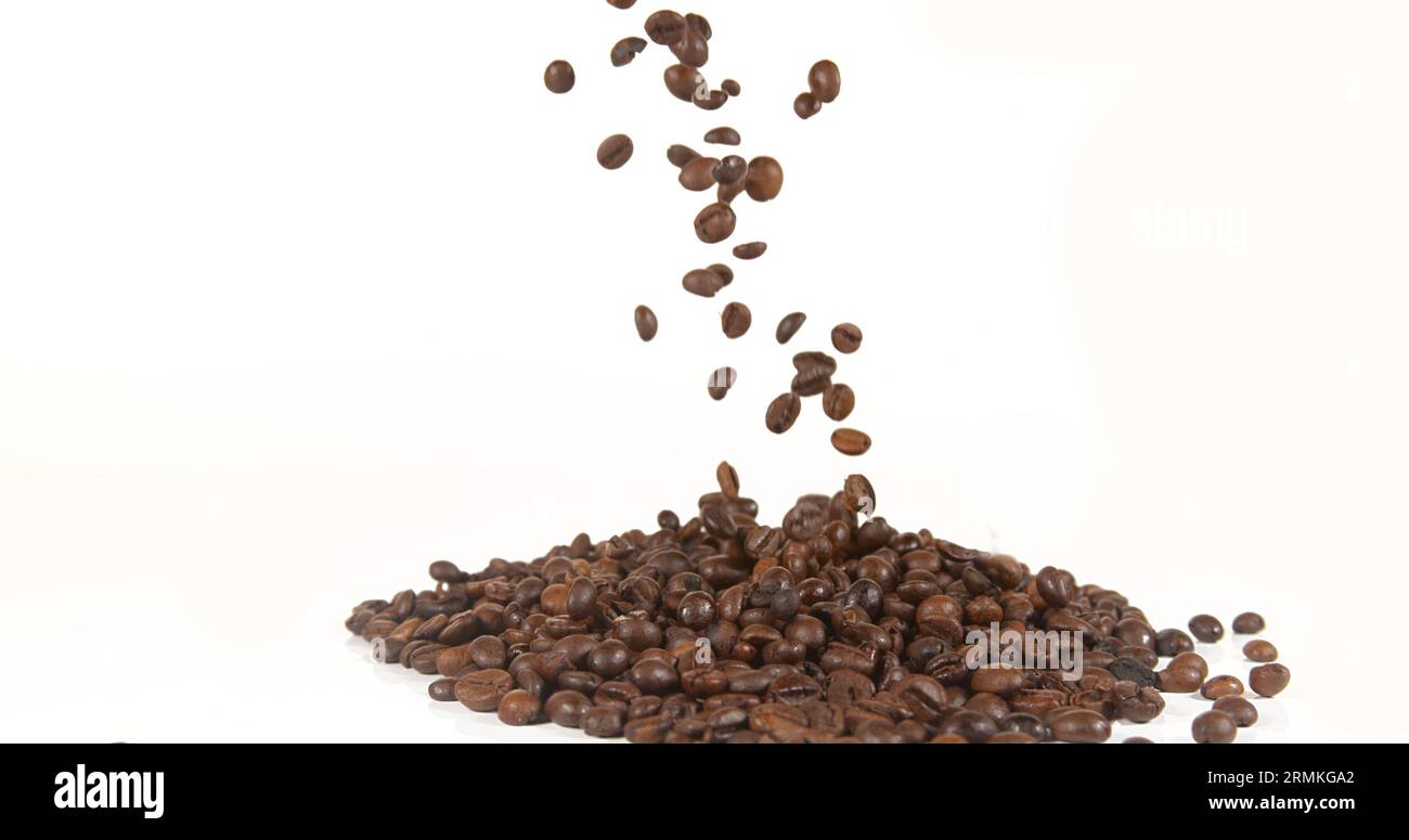 Coffee Beans Falling against White Background Stock Photo - Alamy