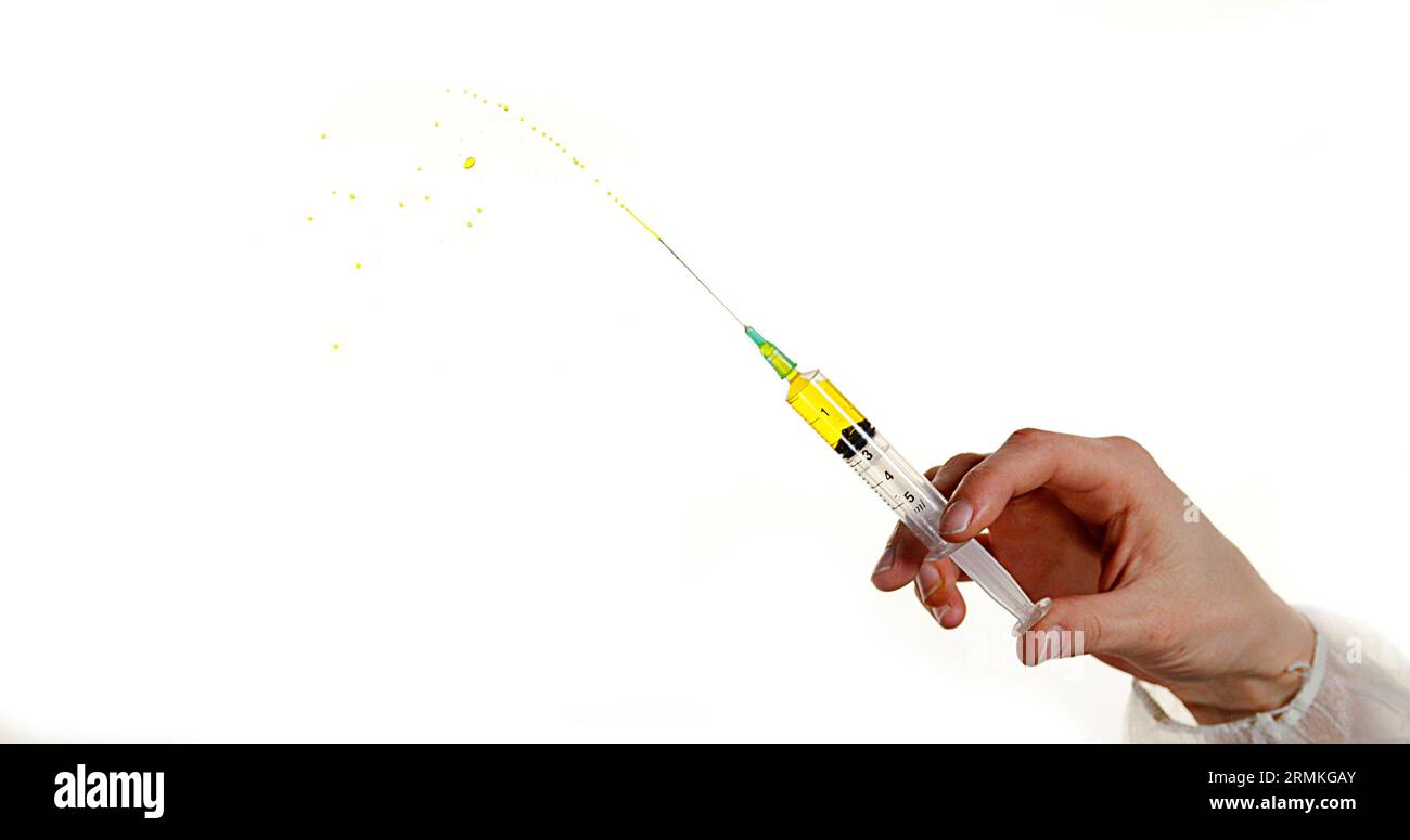 Liquid squirting from Needle against White Background Stock Photo - Alamy