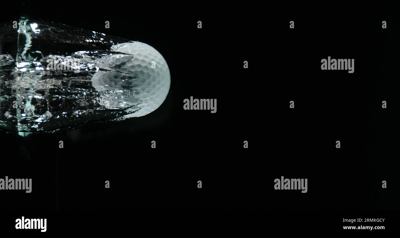 Golf's Ball Falling into Water against Black background Stock Photo - Alamy