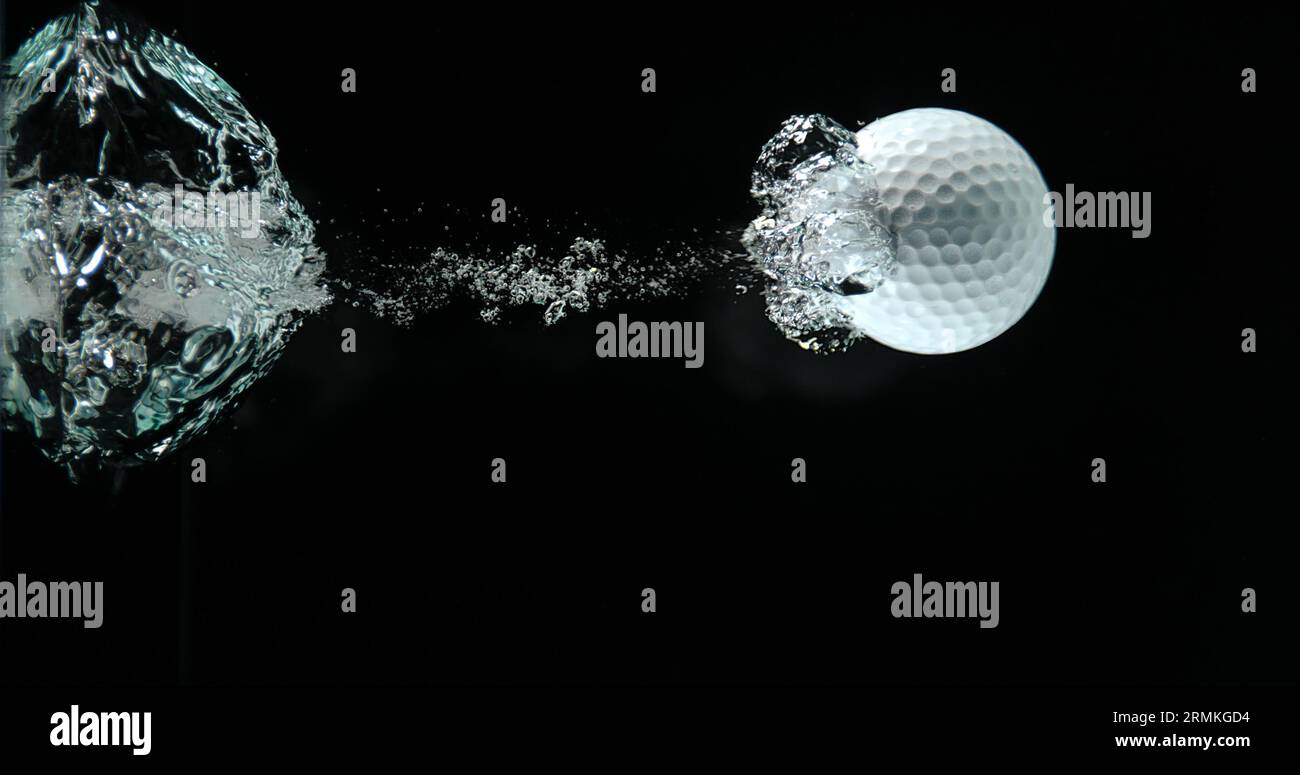 Golf's Ball Falling into Water against Black background Stock Photo - Alamy