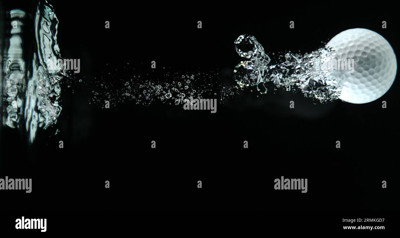 Golf's Ball Falling into Water against Black background Stock Photo - Alamy