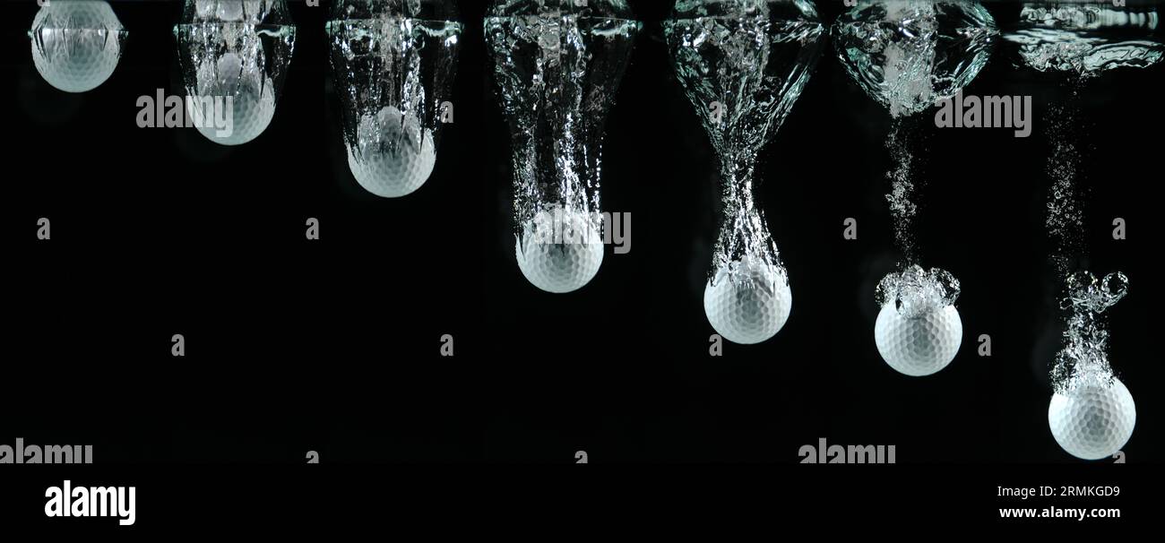 Golf's Ball Falling into Water against Black background Stock Photo - Alamy