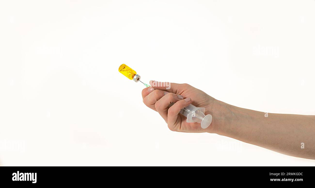 Syringe Falling into Hand against White Background Stock Photo - Alamy